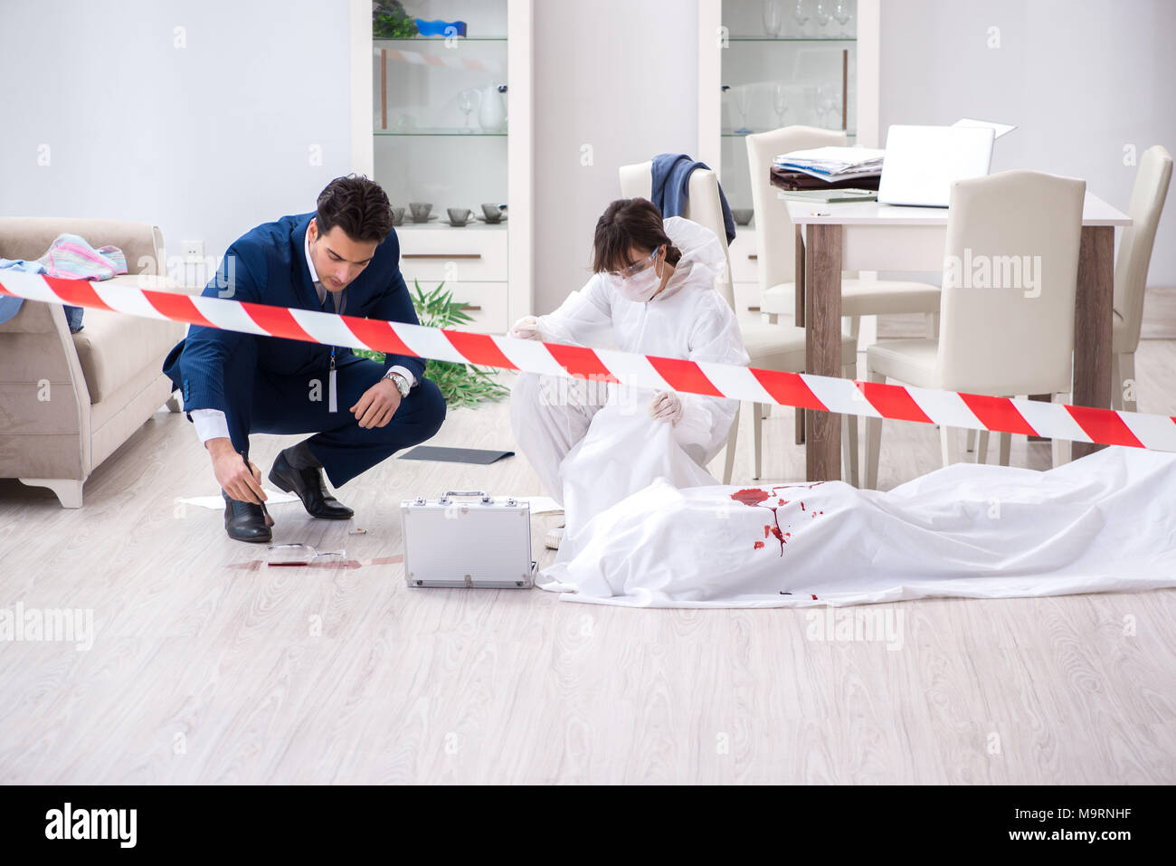 Forensics investigator at the scene of office crime Stock Photo - Alamy