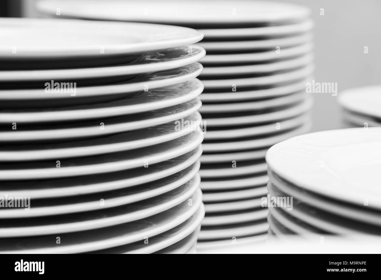 Many white ceramic clean modern dishes on table Stock Photo - Alamy