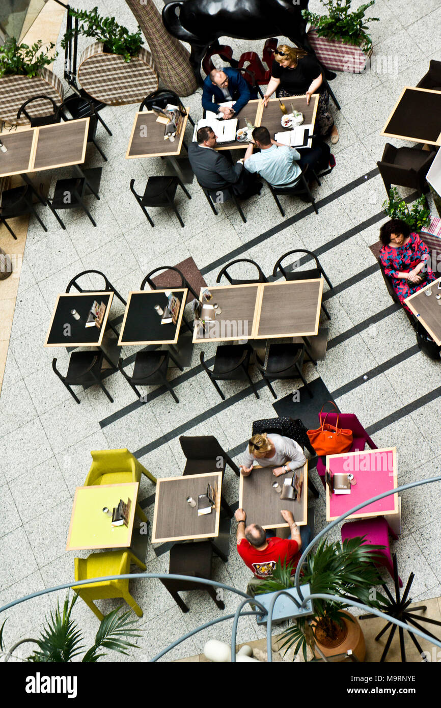 view from above of people sitting at tables in a coffee bar Stock Photo ...