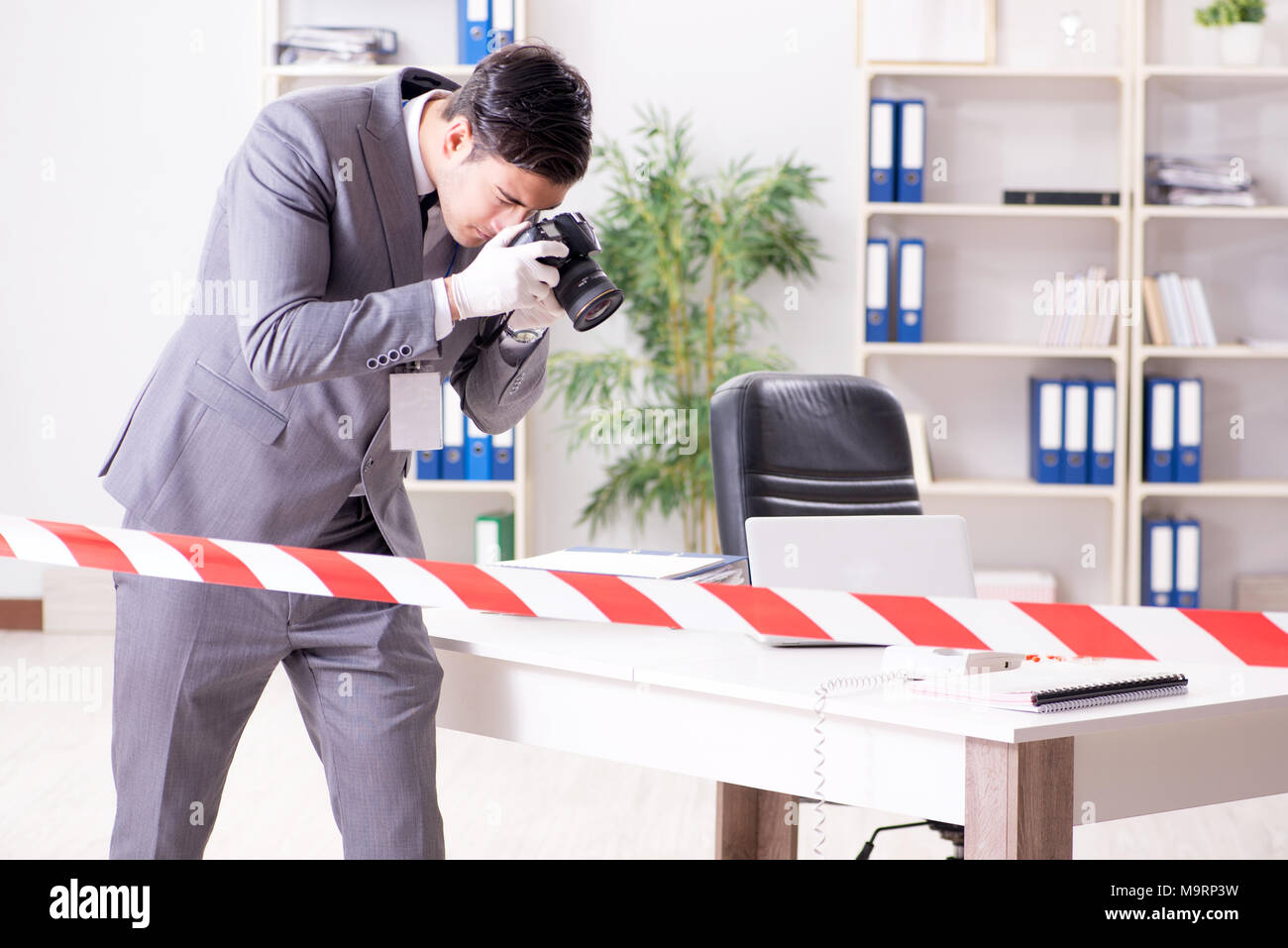 Forensics investigator at the scene of office crime Stock Photo - Alamy