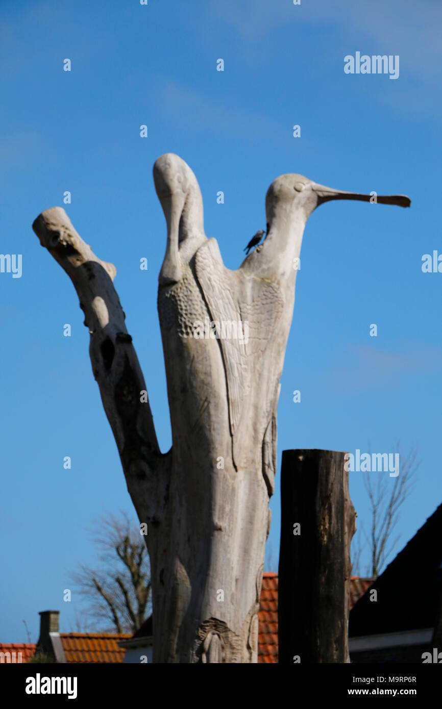 a tree trunk in which animals are cut out Stock Photo - Alamy