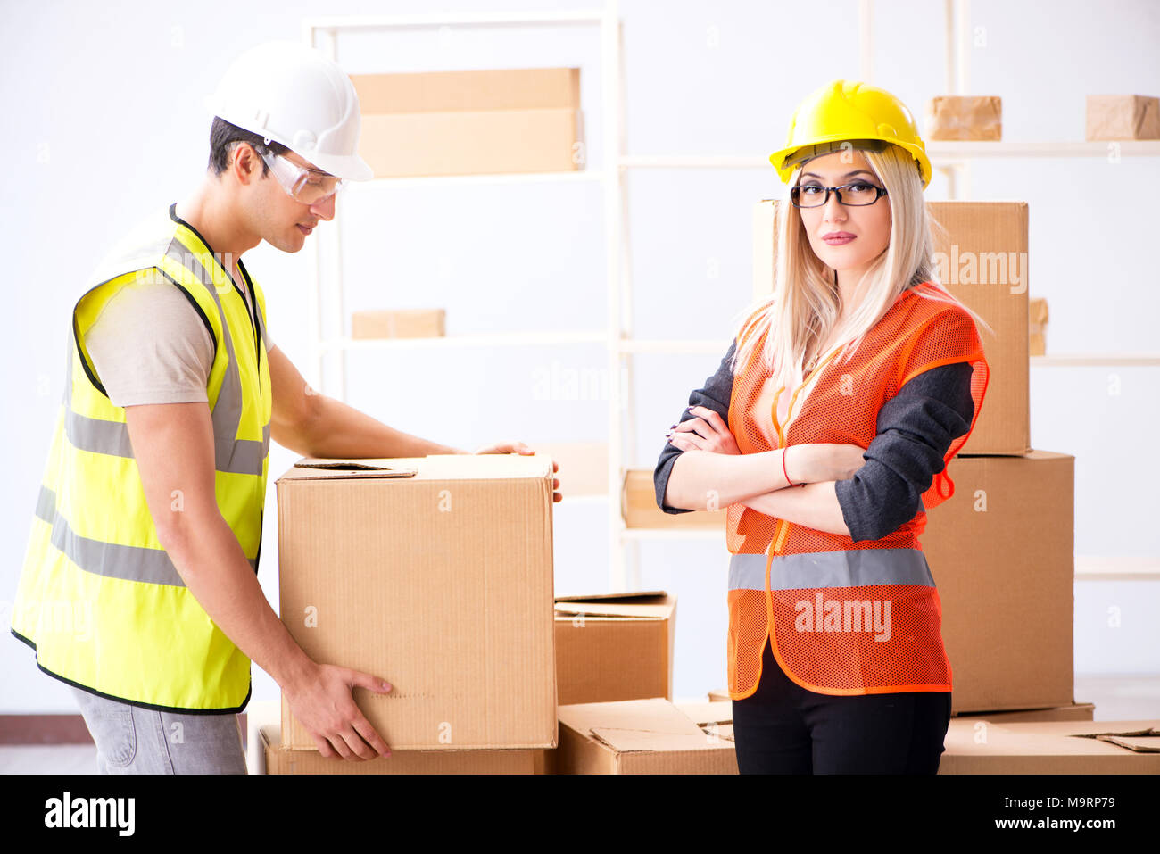 Delivery contractor delivering boxes to office Stock Photo - Alamy