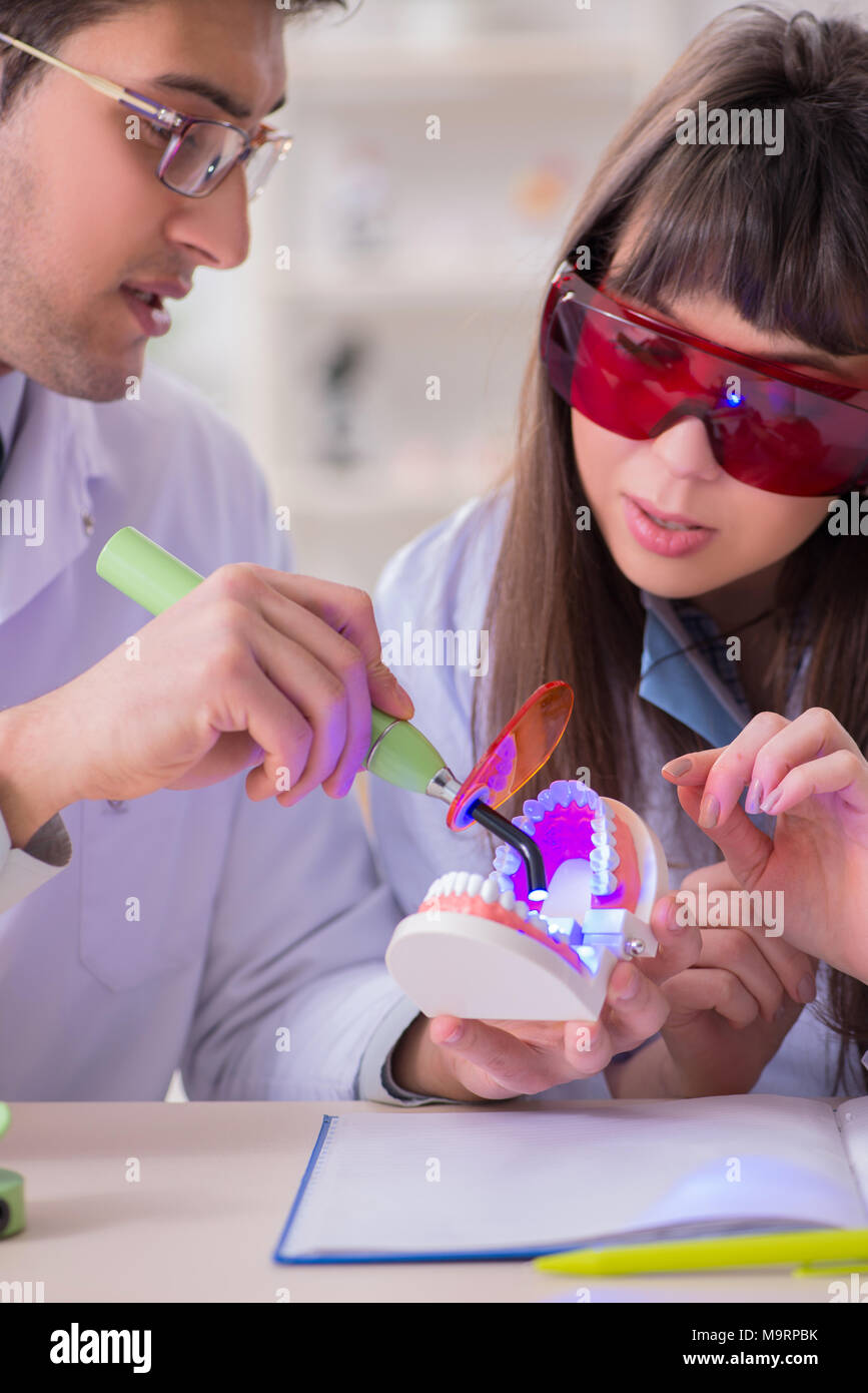 Doctor explaining to assistant how to use ultraviolet gun Stock Photo ...