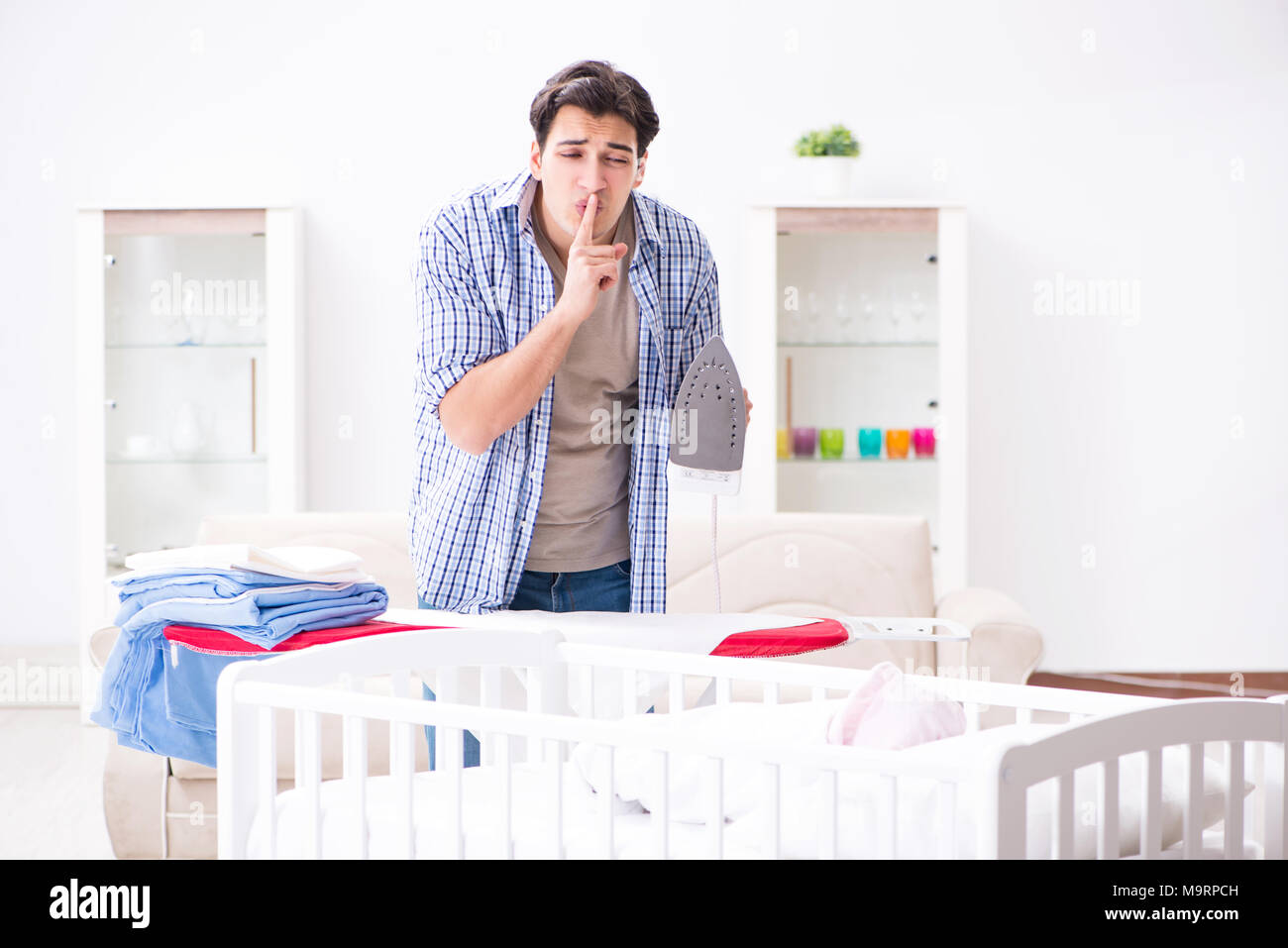 Young dad looking after newborn baby Stock Photo - Alamy