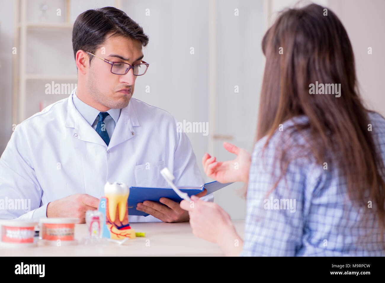 Patient visiting dentist doctor for preliminary appointment Stock Photo ...