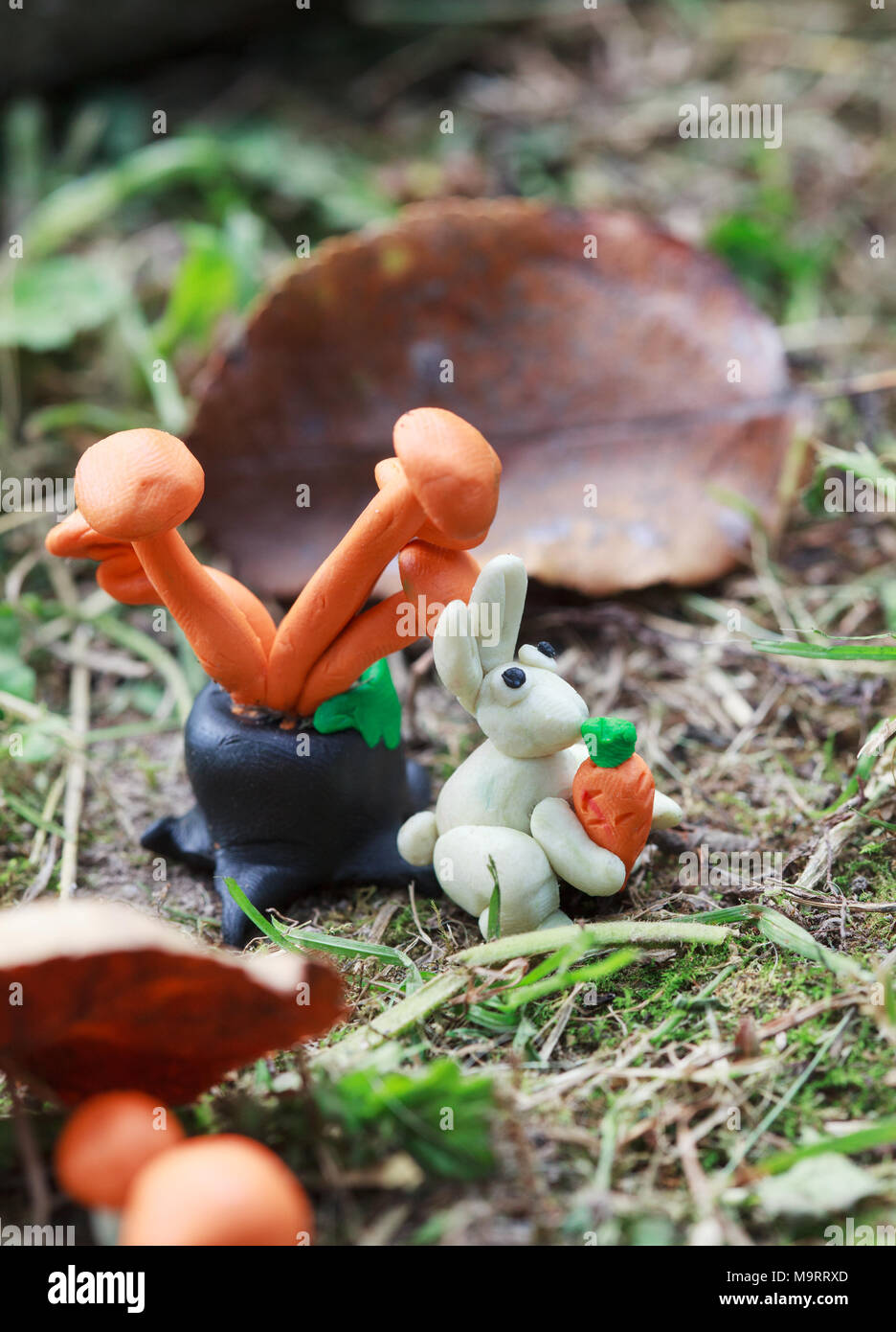 Plasticine world - little homemade white rabbit with carrot sitting ...