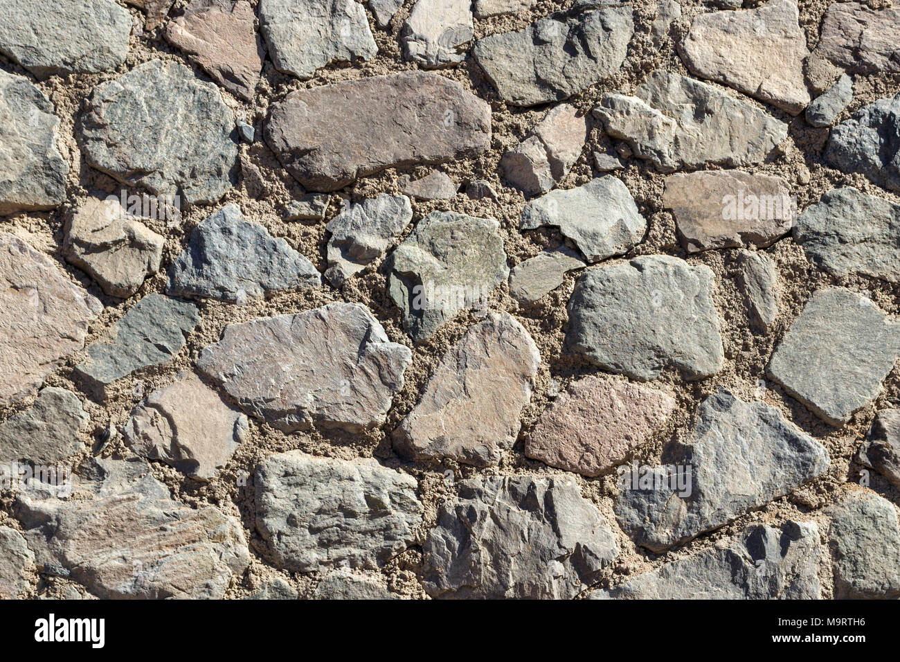 Fragment of a wall from a chipped stone. stone wall background or ...