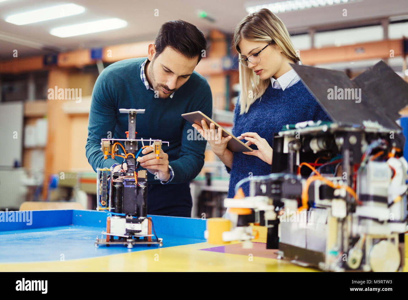 Young students of robotics working on project Stock Photo - Alamy