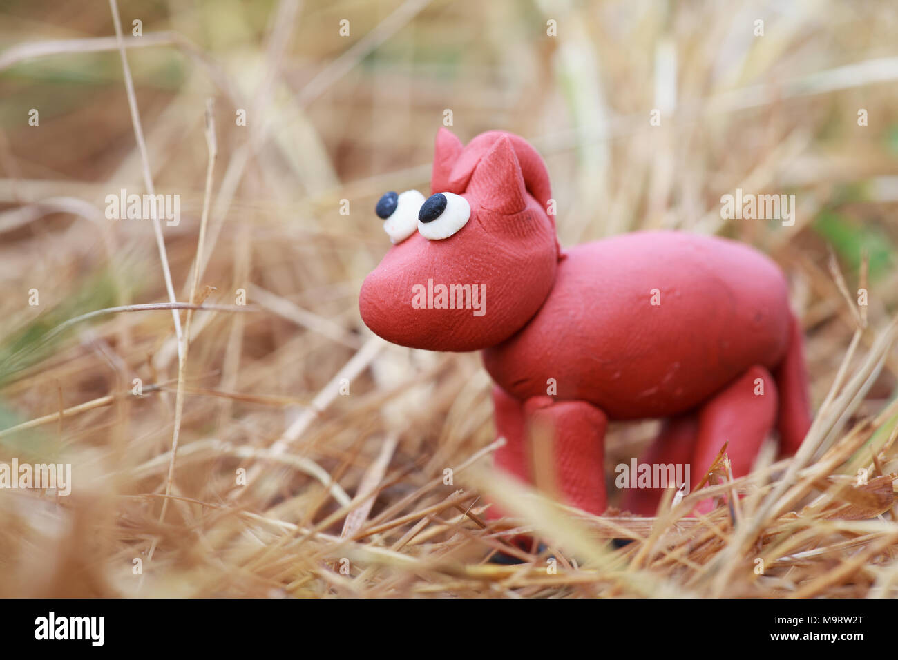 Plasticine world - little homemade red horse stands in the hay ...