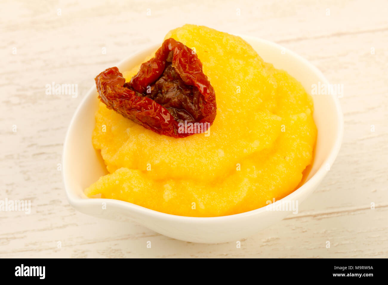 Polenta with dry tomato Stock Photo - Alamy