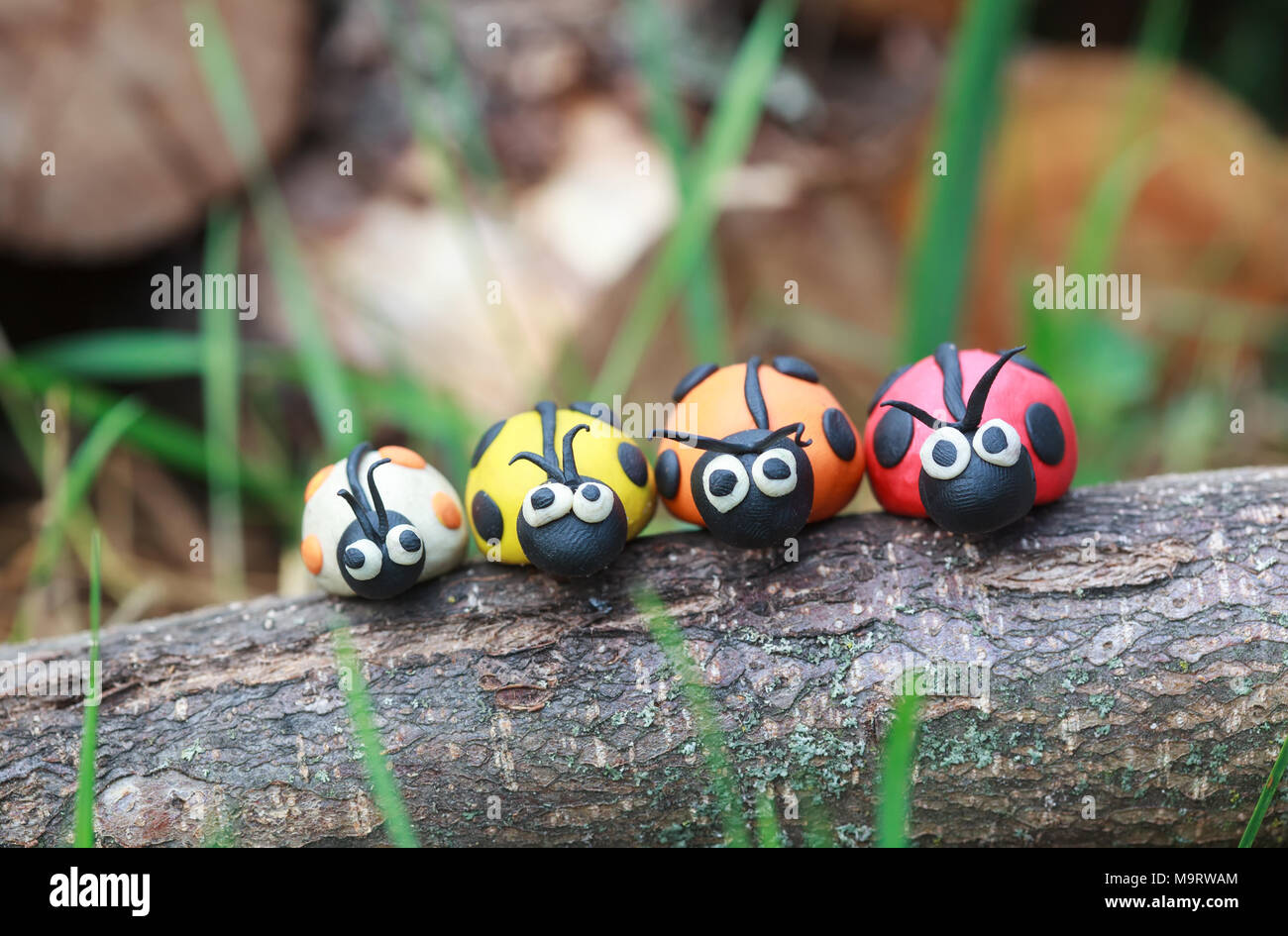 Plasticine world - four little homemade colorful ladybirds sitting on a ...