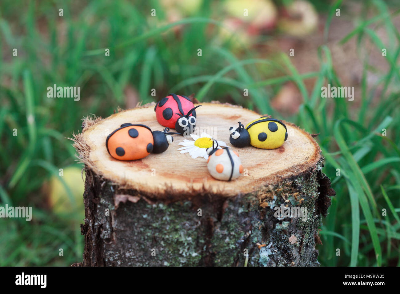 Plasticine world - four little homemade colorful ladybirds sitting on a ...