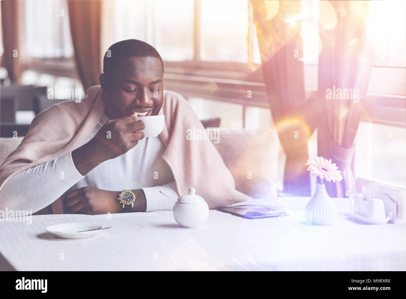 Pleased male person drinking tea Stock Photo - Alamy