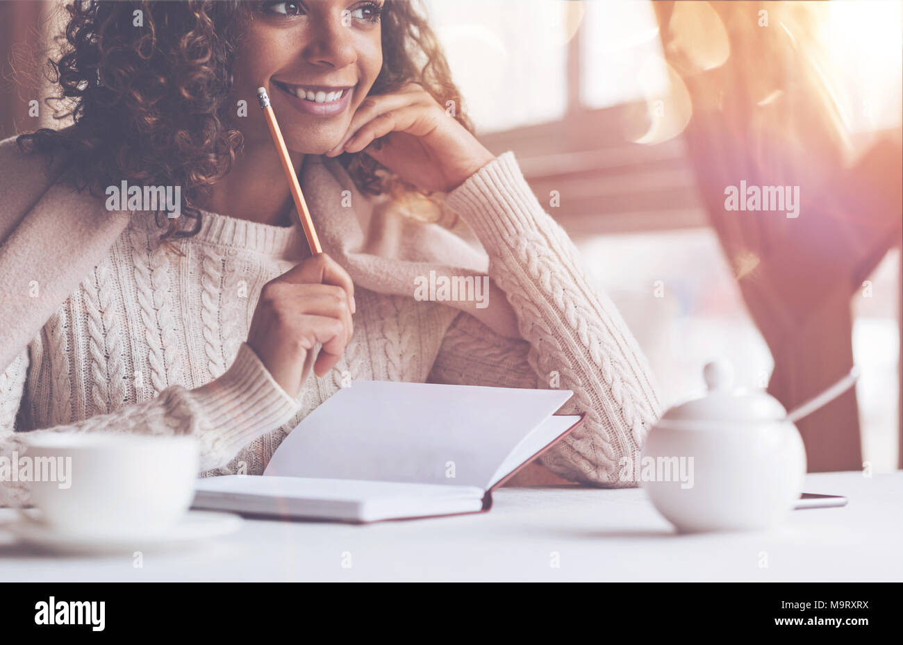 Portrait of smiling woman keeping her notebook opened Stock Photo - Alamy
