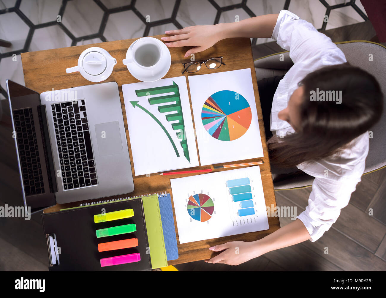 Top view on working office desk with documents and laptop. Overhead ...