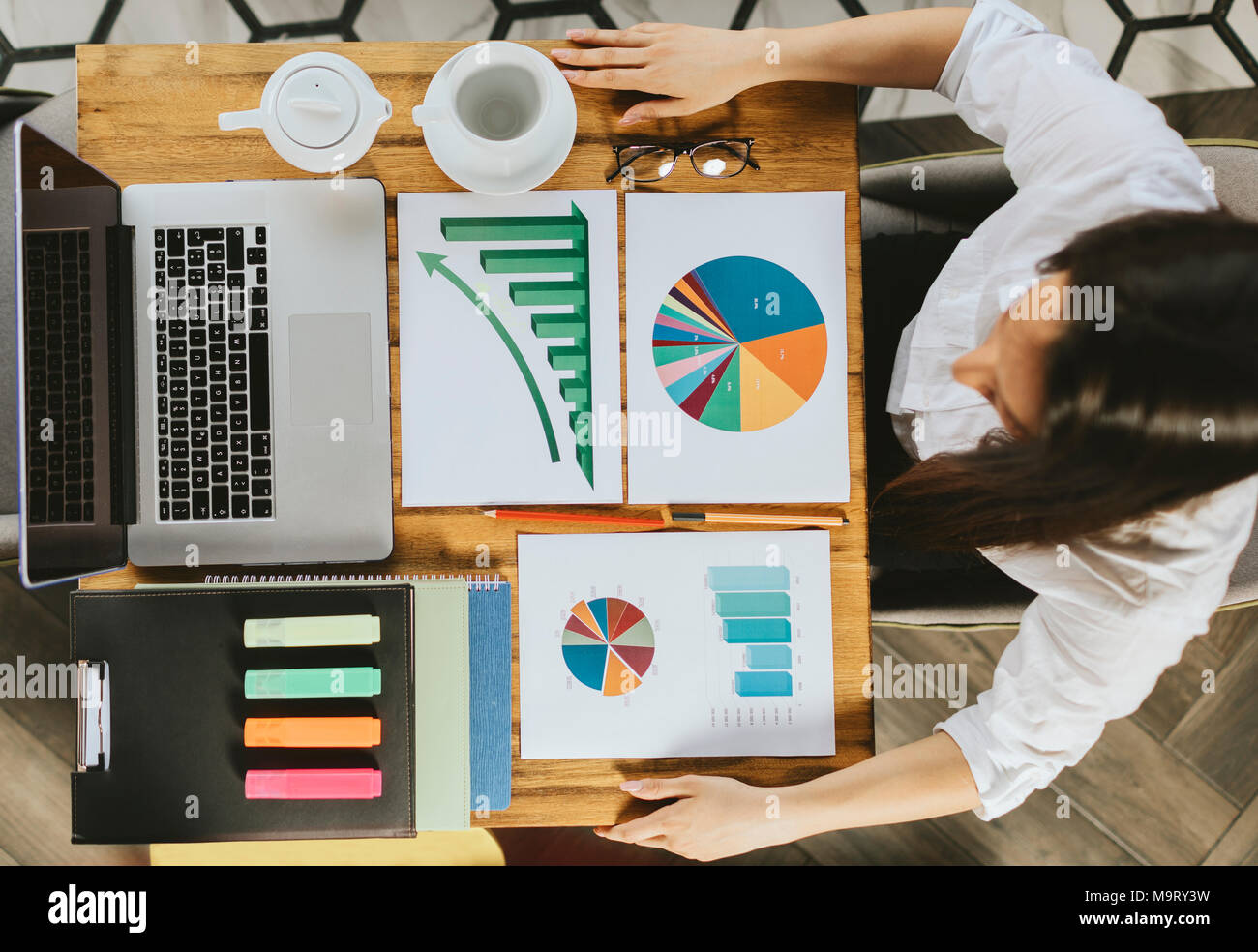 Top view on working office desk with documents and laptop. Overhead ...