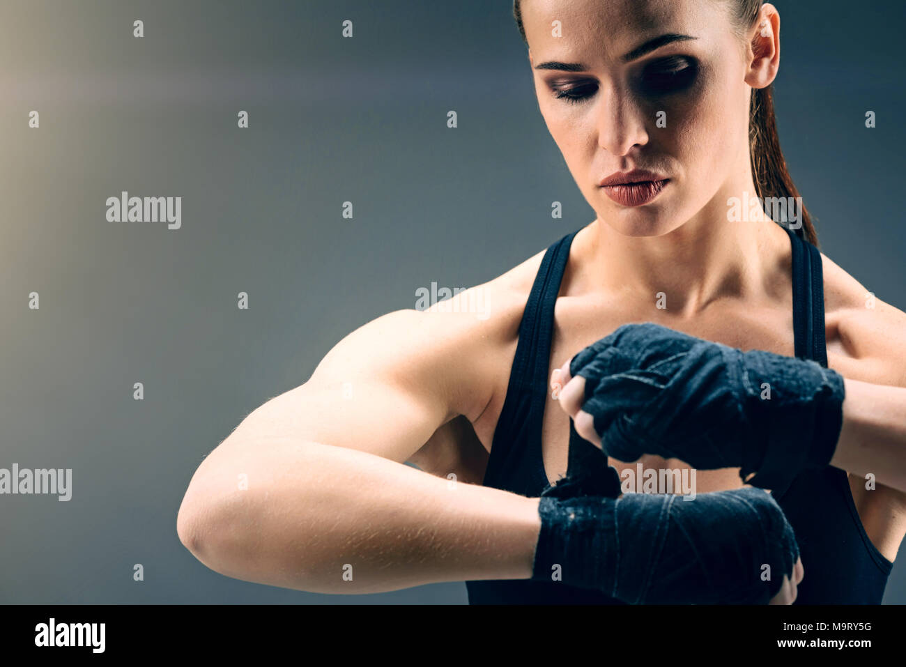 Scaled up look on beautiful female boxer wrapping hands Stock Photo - Alamy