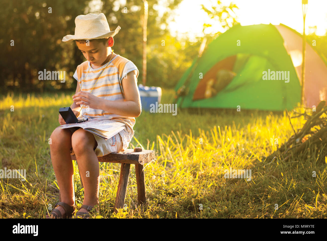 child on a camping learns to use a compass Stock Photo - Alamy