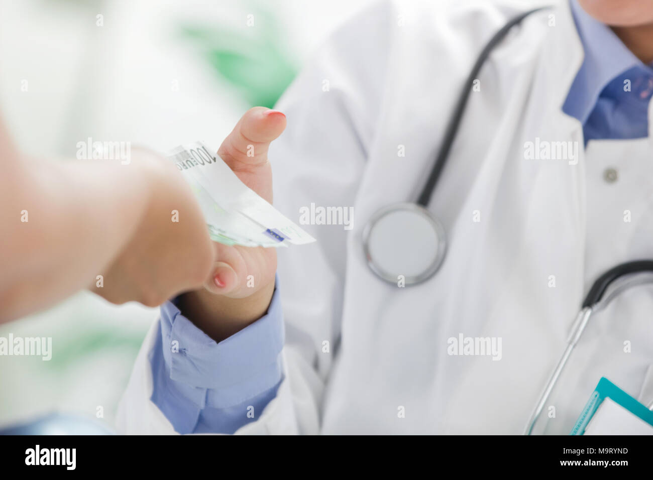 female doctor receiving money from a patient Stock Photo - Alamy