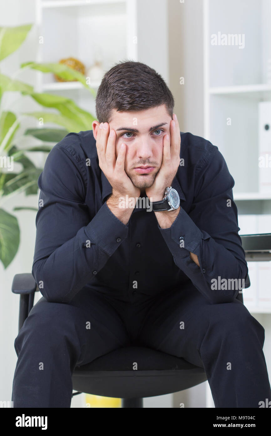 Tense man in suit sitting hi-res stock photography and images - Alamy