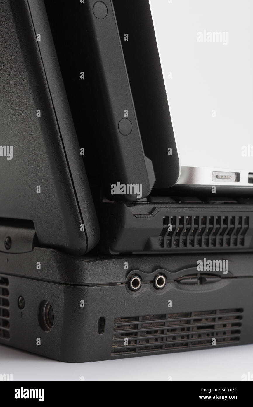 Comparing of laptops, new modern and two old laptops, present and past ...