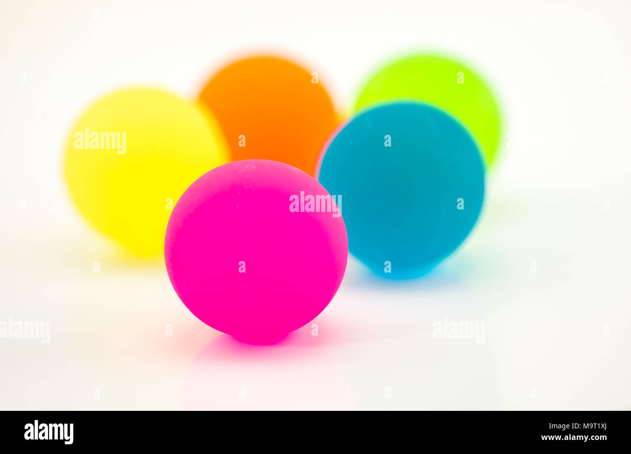 Rubber balls on white background Stock Photo - Alamy