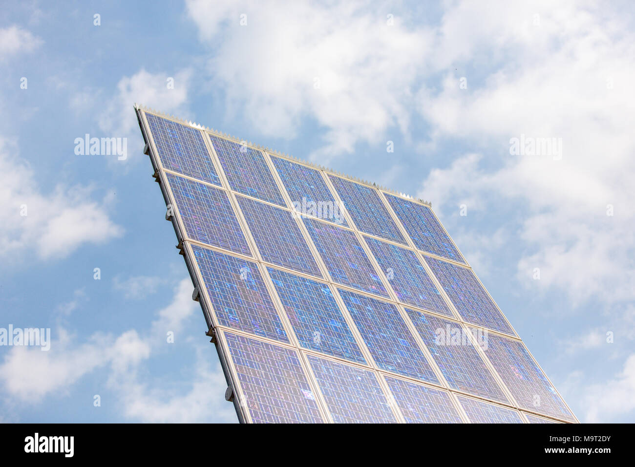 Pole with 20 solar panels collecting sunlight in a blue sky Stock Photo ...