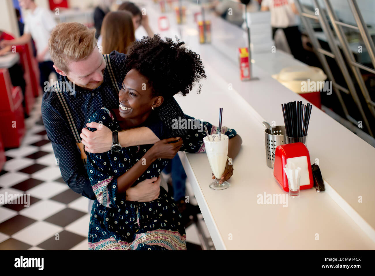 View at couple hugging by the bar in the diner Stock Photo - Alamy
