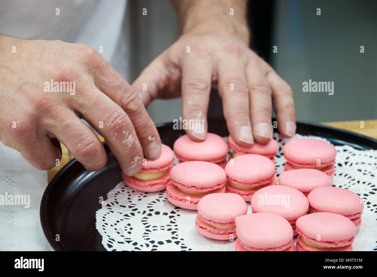 chef with macaroons on tray at bakery Stock Photo - Alamy