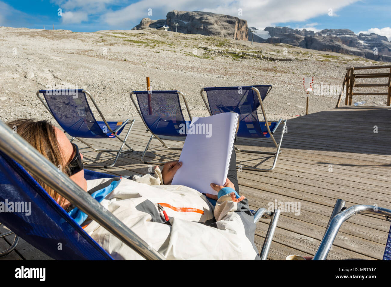 Female reading a script in mountain resort Stock Photo - Alamy
