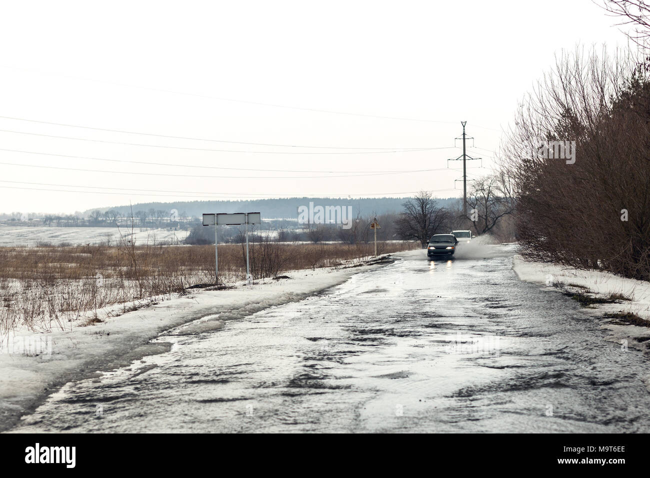 Flooding of road due to snow melting and rising of water level. Spring ...