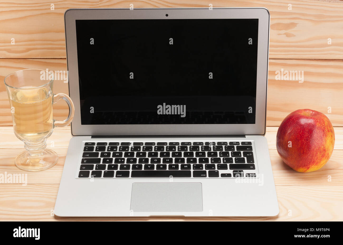 Open modern, new laptop with apple on wooden background, front view ...