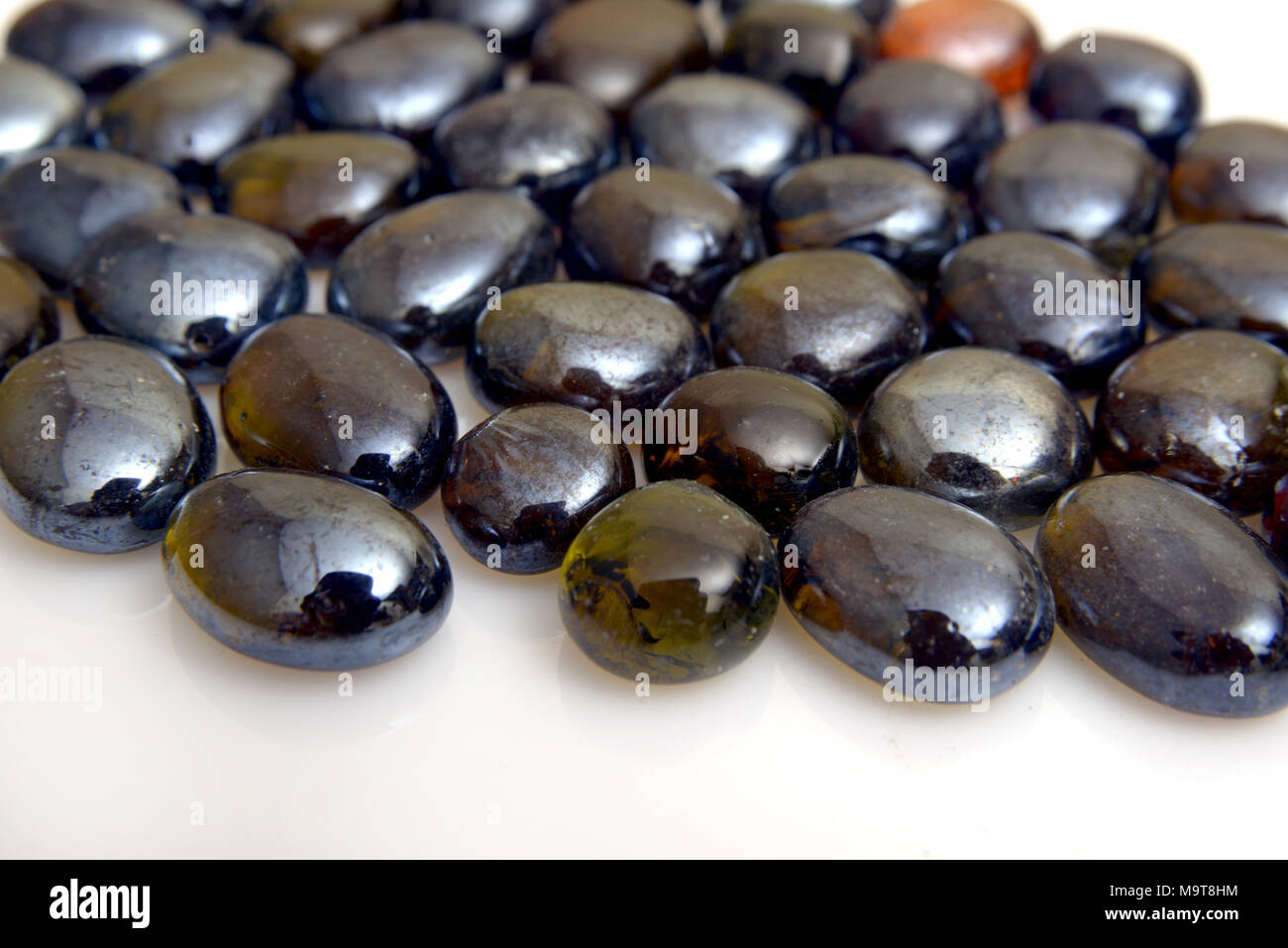 Black and brown artificial pebbles on white background Stock Photo - Alamy