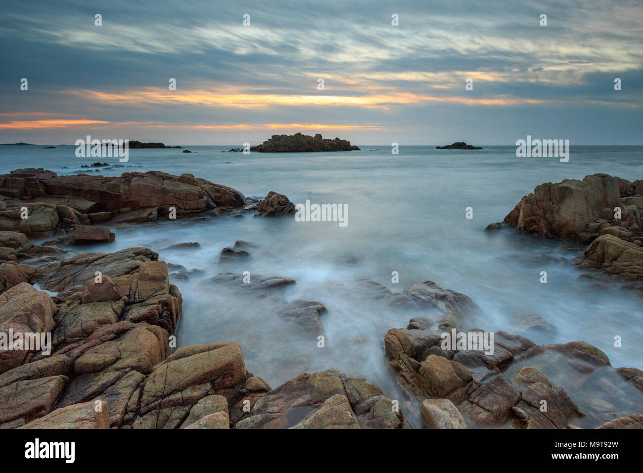 Sunset in Guernsey, channel islands with long exposure Stock Photo - Alamy