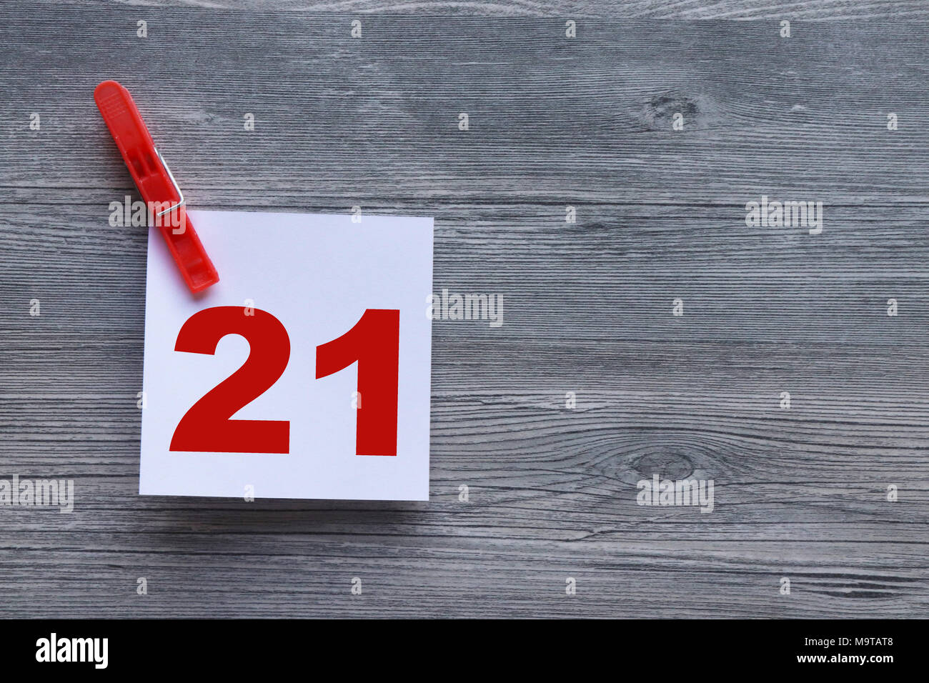 Series of red numbers on white note paper, held by red clothes peg, on ...