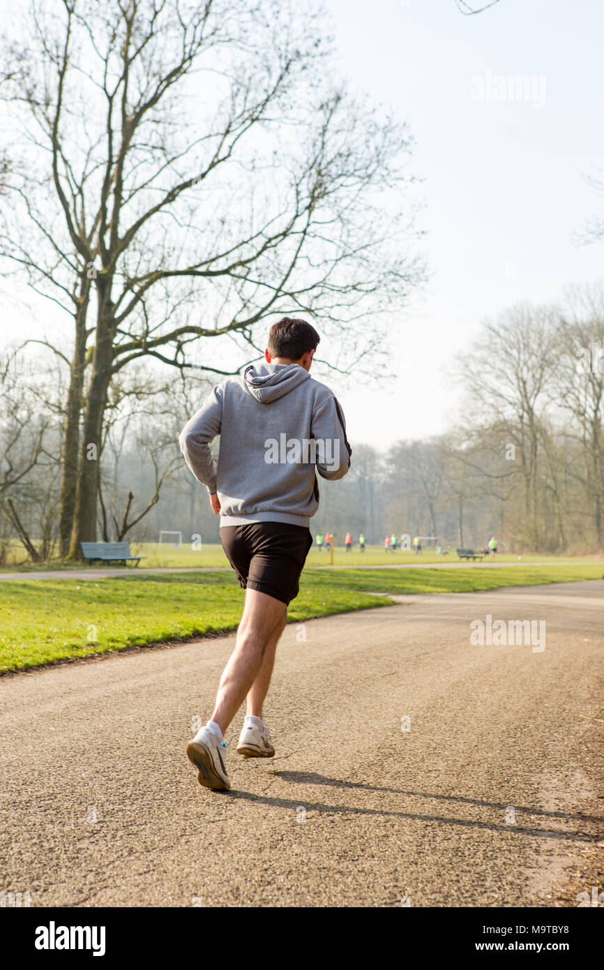 Man running on a asphalt path in the Amsterdamse Bos Stock Photo - Alamy