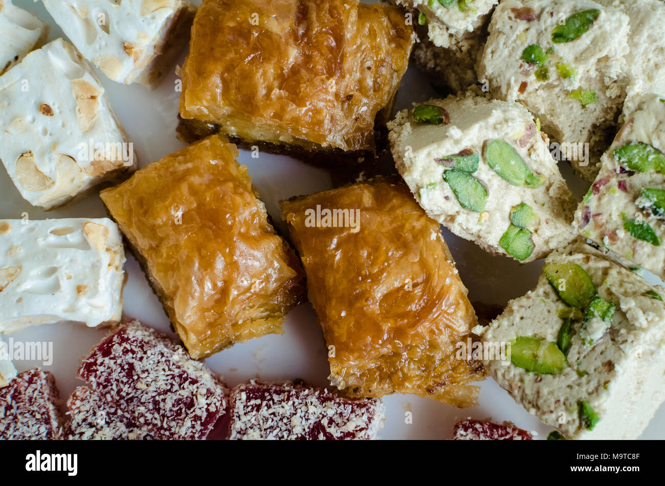 Assorted traditional eastern desserts on a white wooden background ...