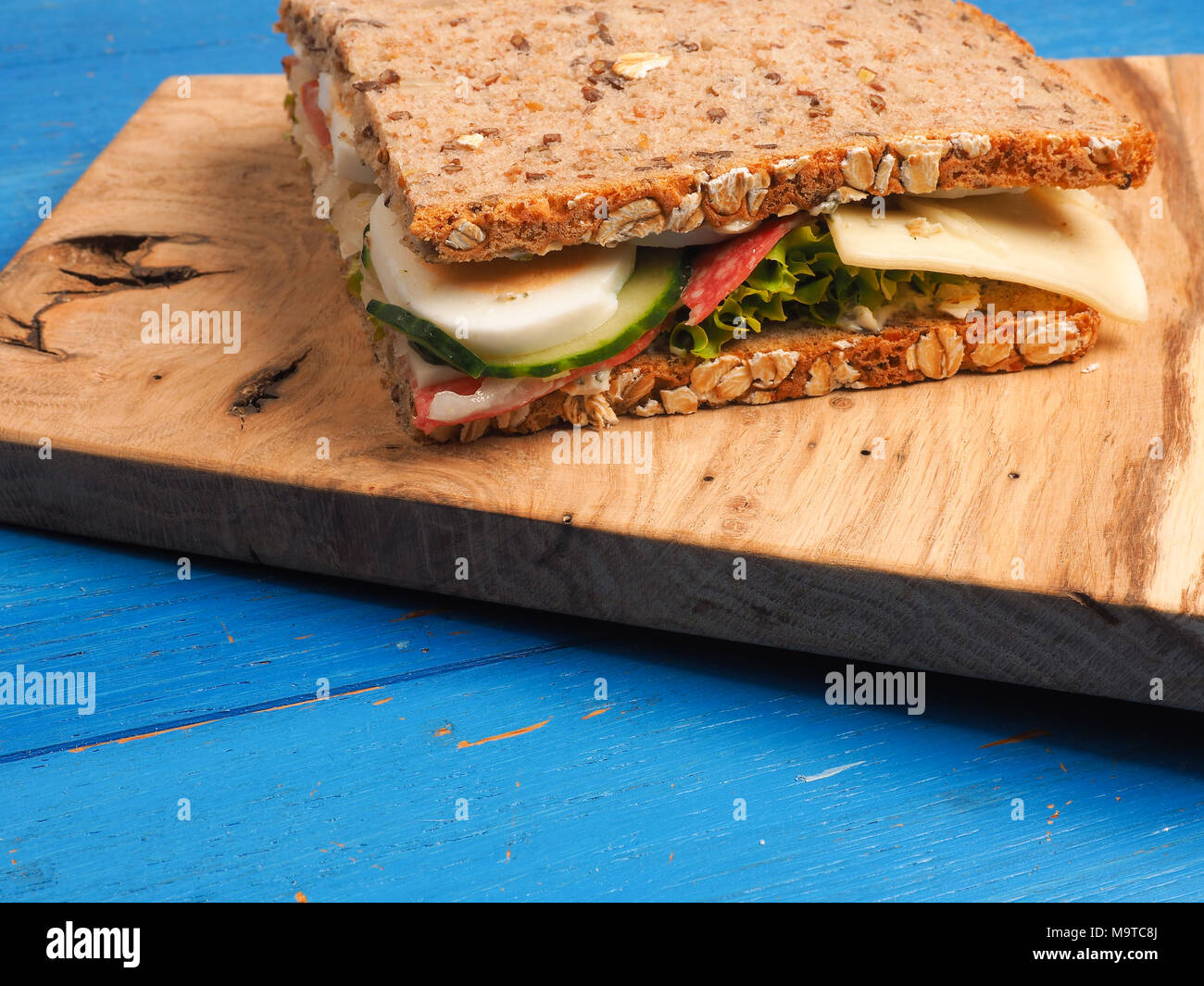 Tasty whole grain sandwich on a blue kitchen table, healthy eating ...