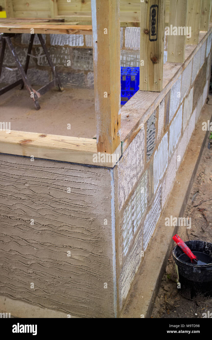 Part constructed garden workshop using reclaimed concrete blocks and ...