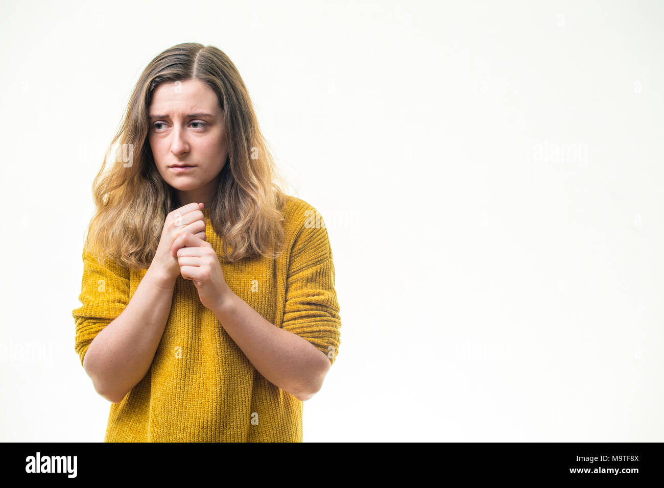 A vulnerable at risk, young Caucasian woman girl alone, looking sad ...