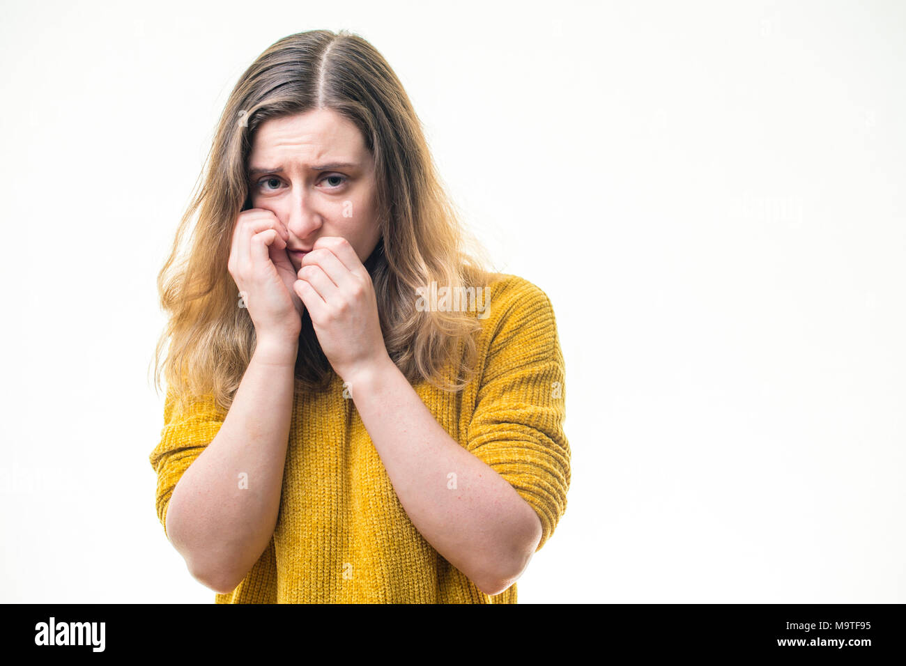 A vulnerable at risk, young Caucasian woman girl alone, looking sad ...
