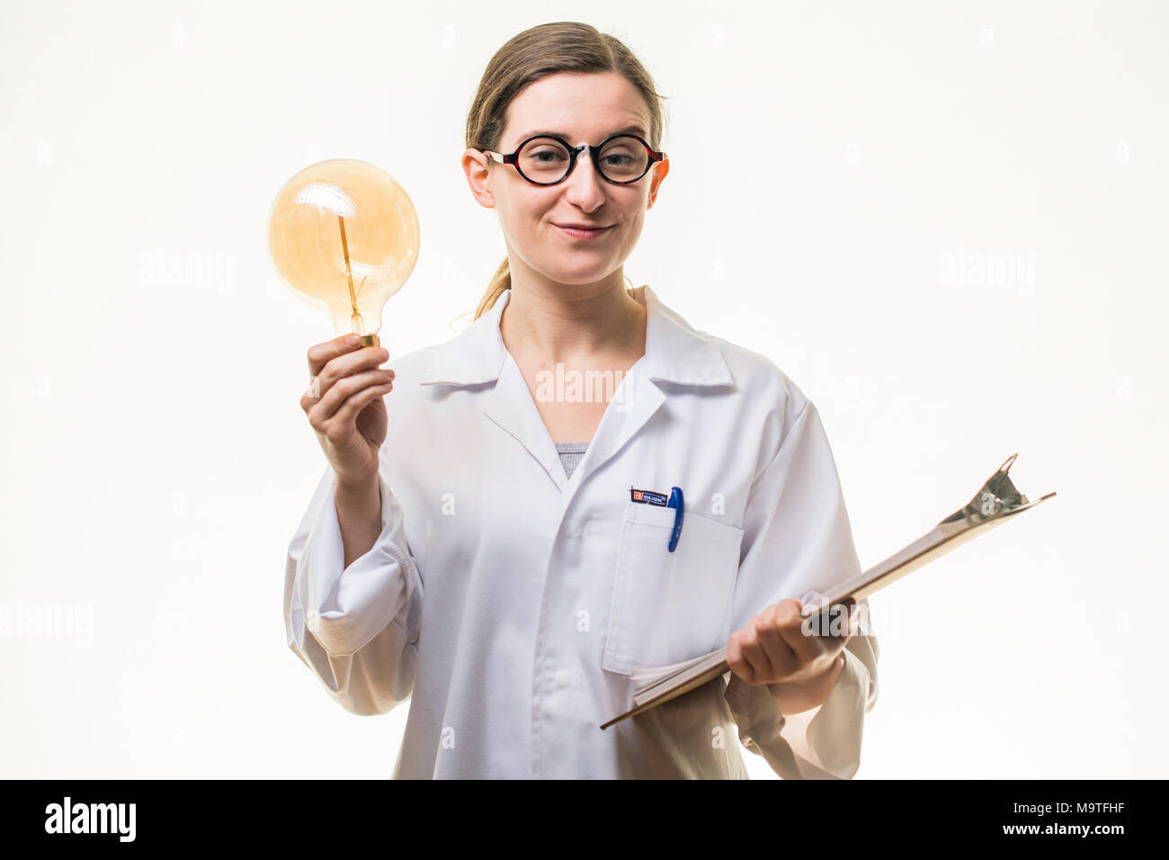A young Caucasian woman girl scientist, wearing a white lab laboratory ...