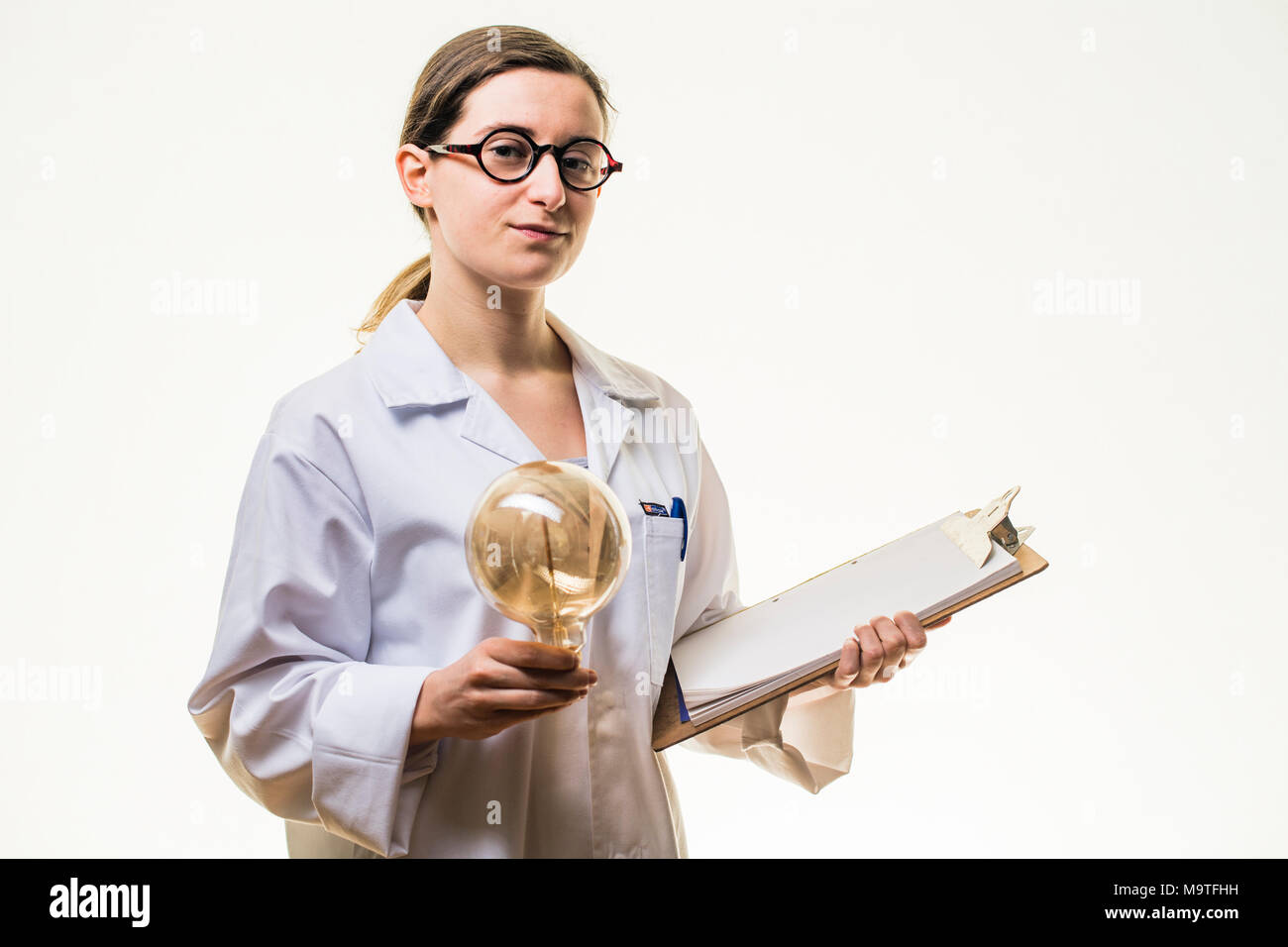 A young Caucasian woman girl scientist, wearing a white lab laboratory ...