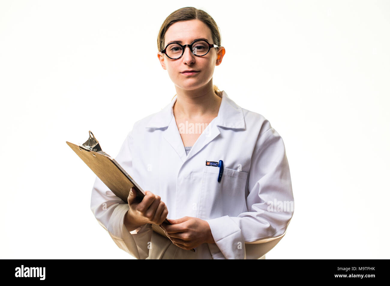 A young Caucasian woman girl scientist, wearing a white lab laboratory ...