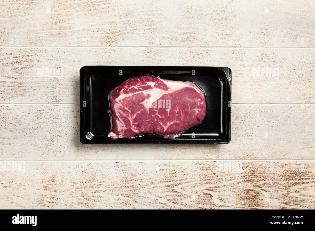 Raw steak in an airtight packaging Stock Photo - Alamy
