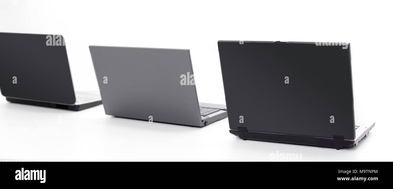 three open laptop in the workplace .isolated on white Stock Photo - Alamy