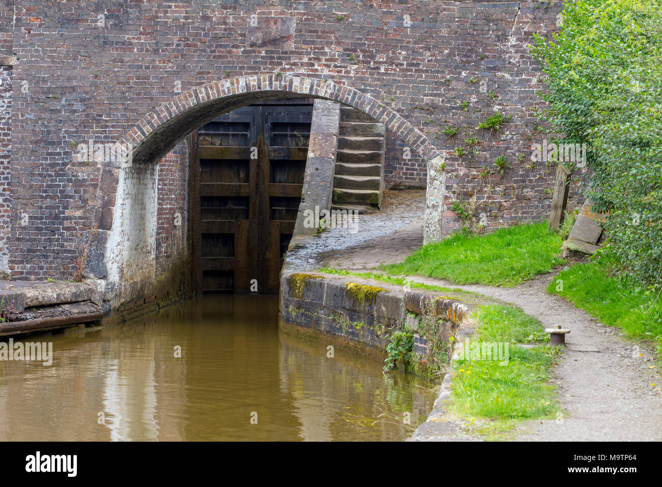 Canal lock with arch bridge in Cheshire UK Stock Photo - Alamy