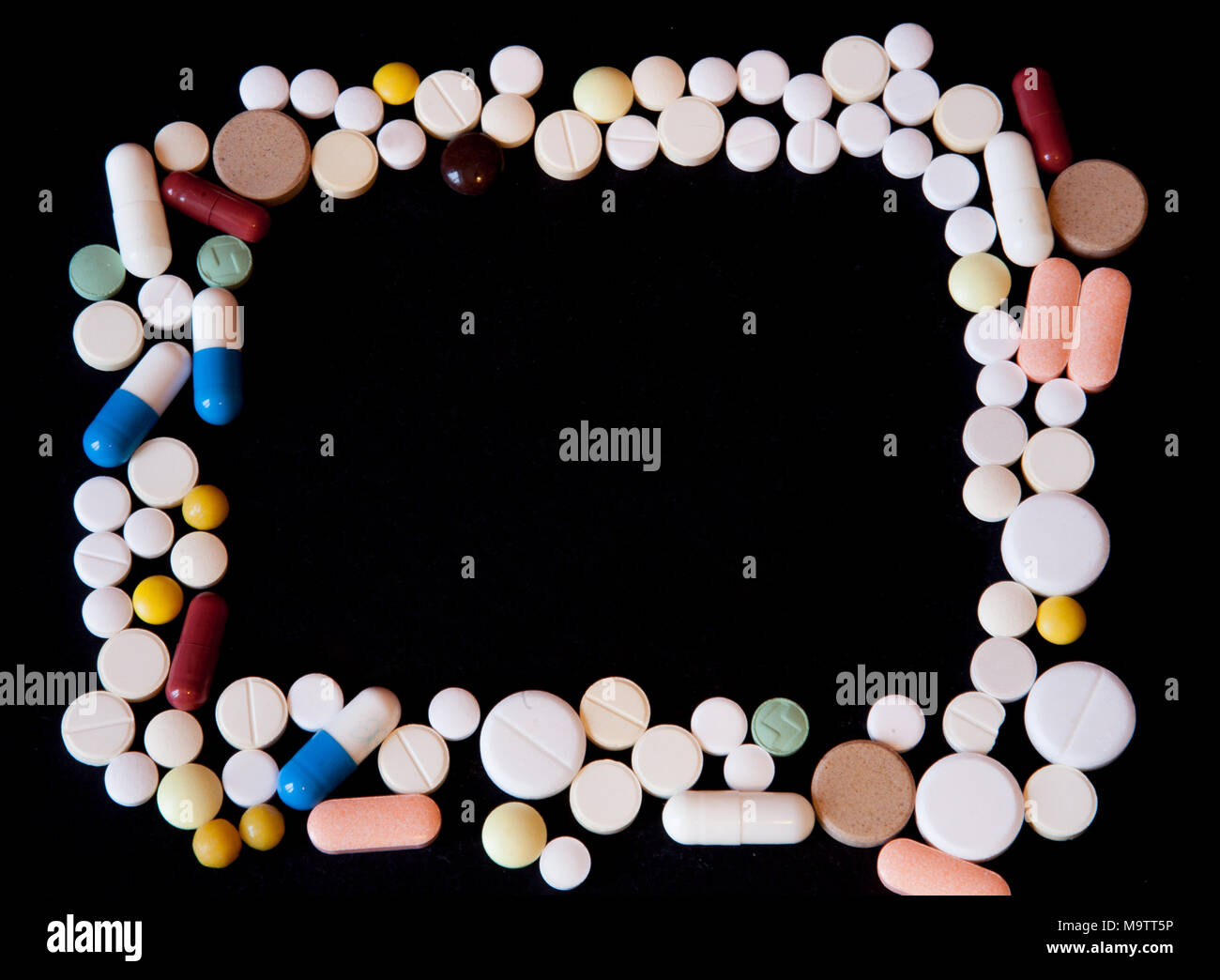 Frame of pills on a dark background with free space for text, top view ...