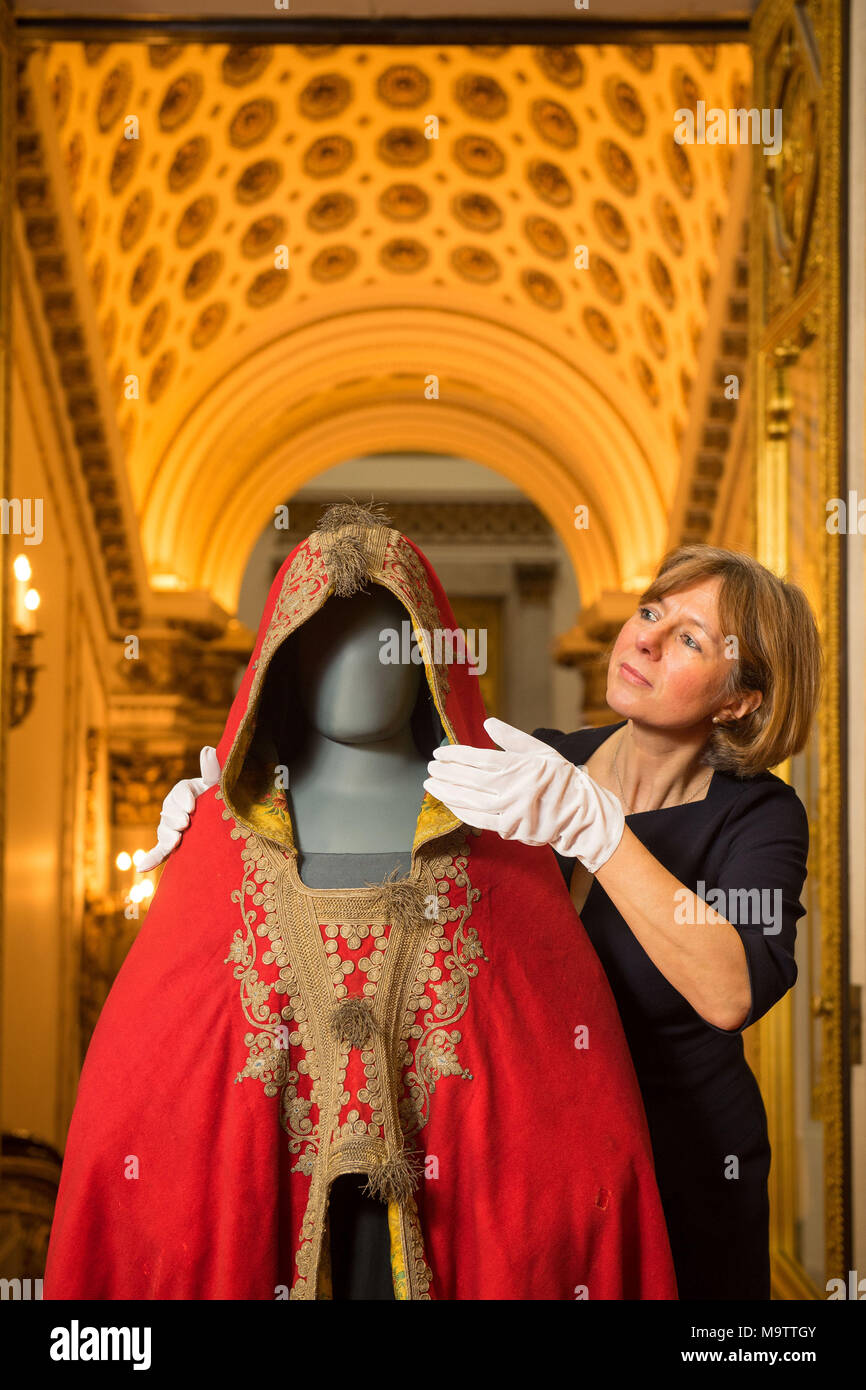 A member of Royal Collection staff adjusts the cloak of Napoleon ...
