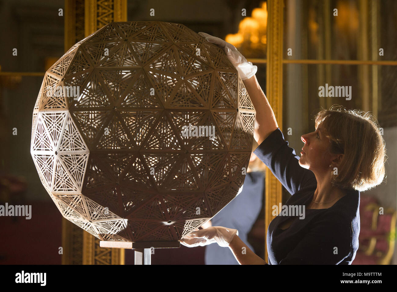 A member of Royal Collection staff with a walnut geodesic dome ...